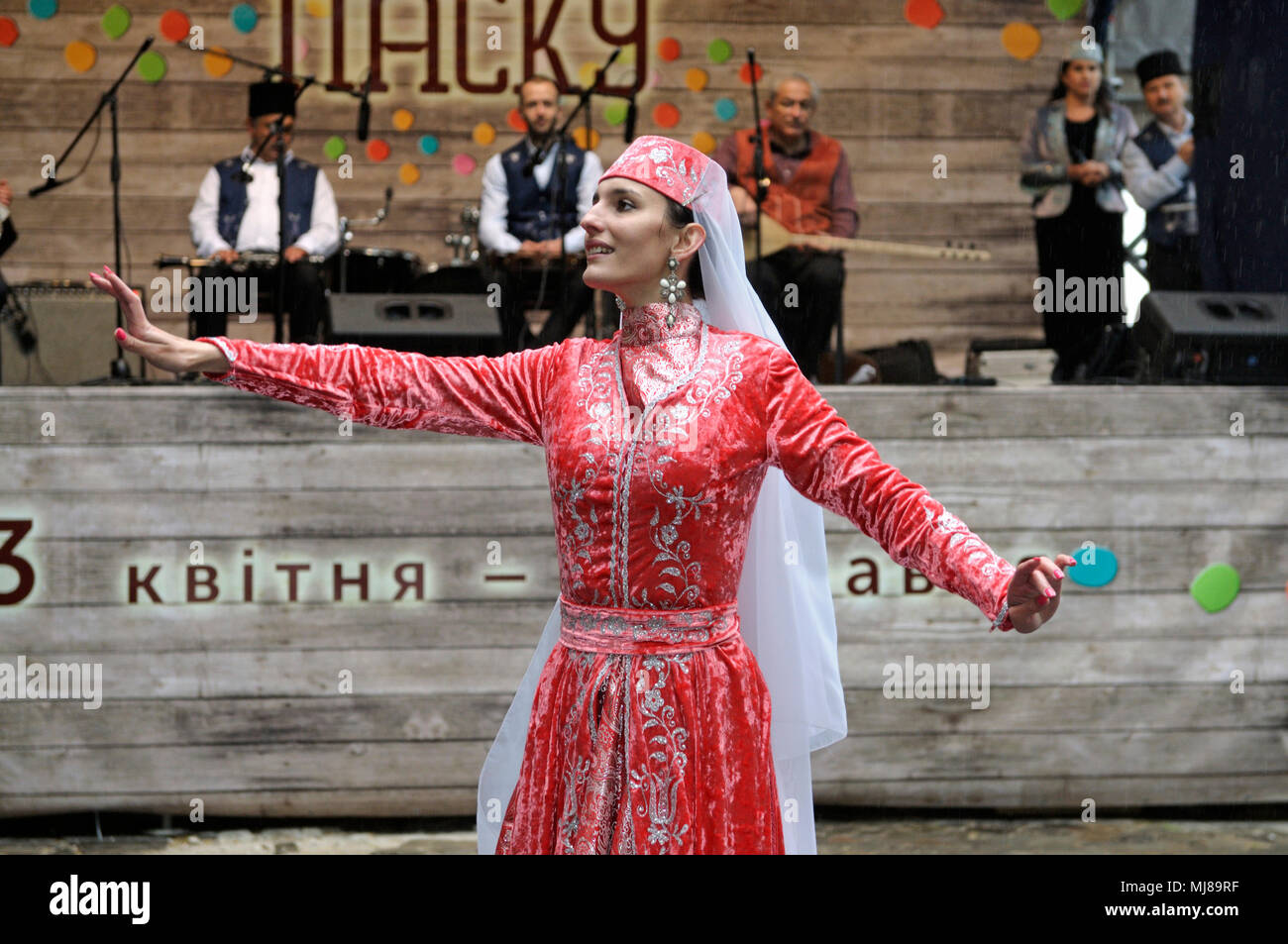 Crimean tatar dancer in a native dress performing native dance on stage ...