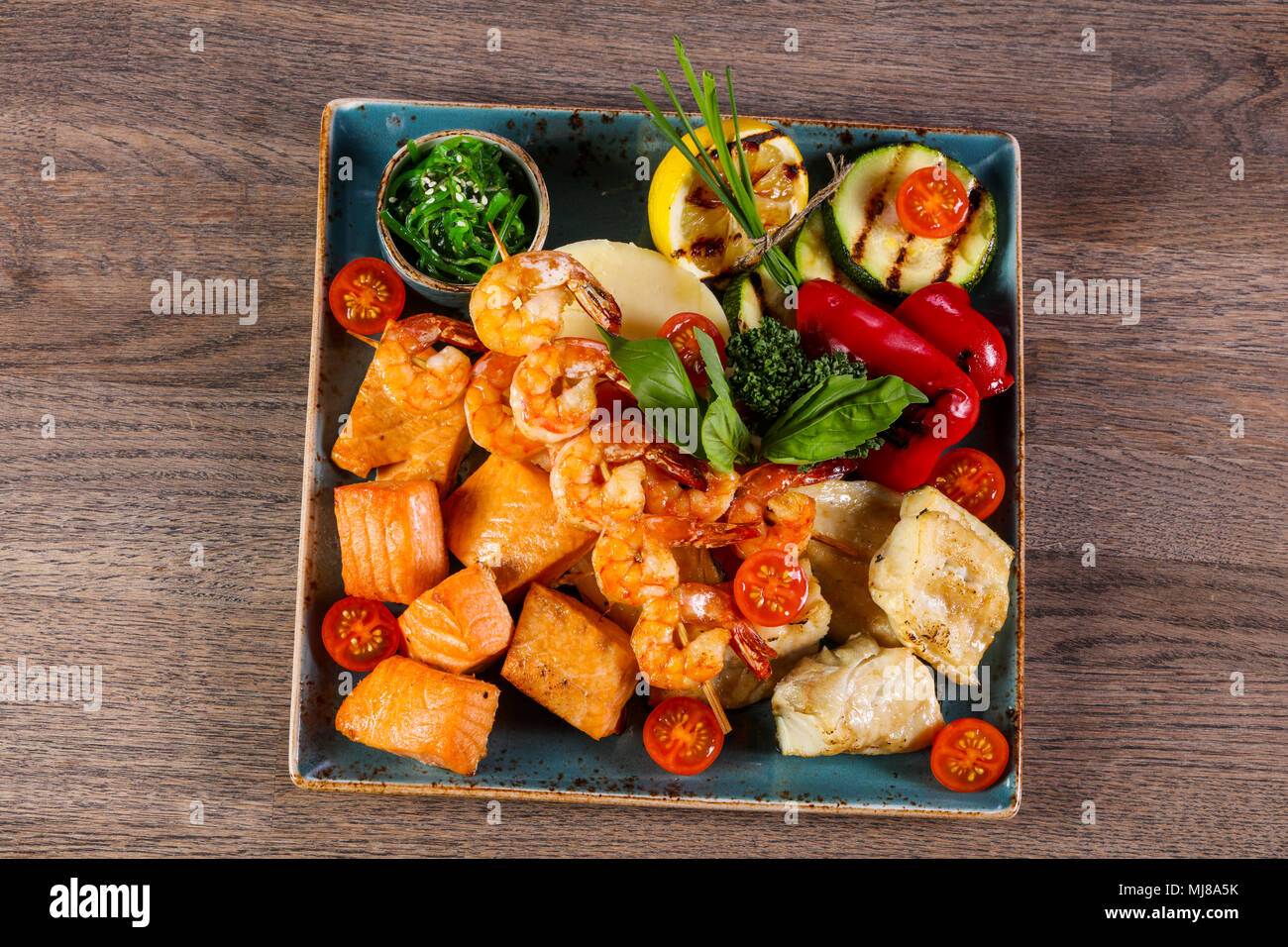 Fish and prawn plate served grilled vegetables Stock Photo - Alamy