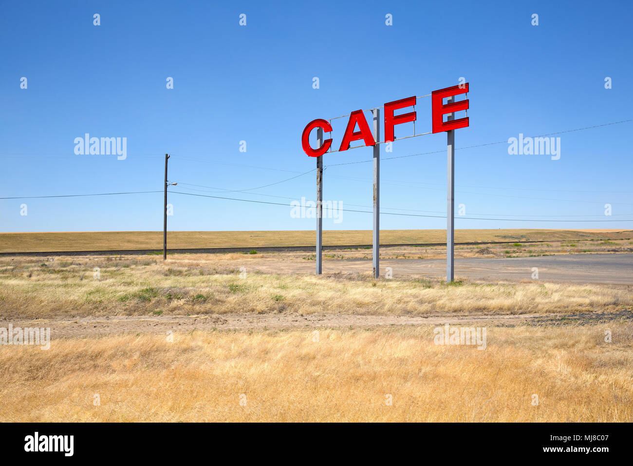 Large red capital letters on metal poles advertising cafe in a prairie ...