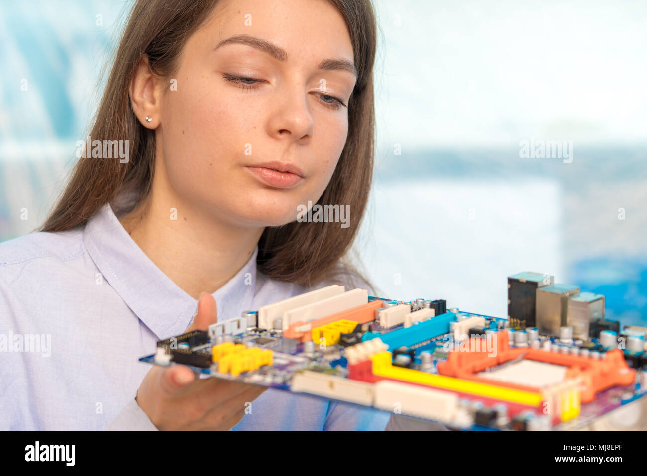 Female student in electronics class uses a Measuring device Stock Photo ...
