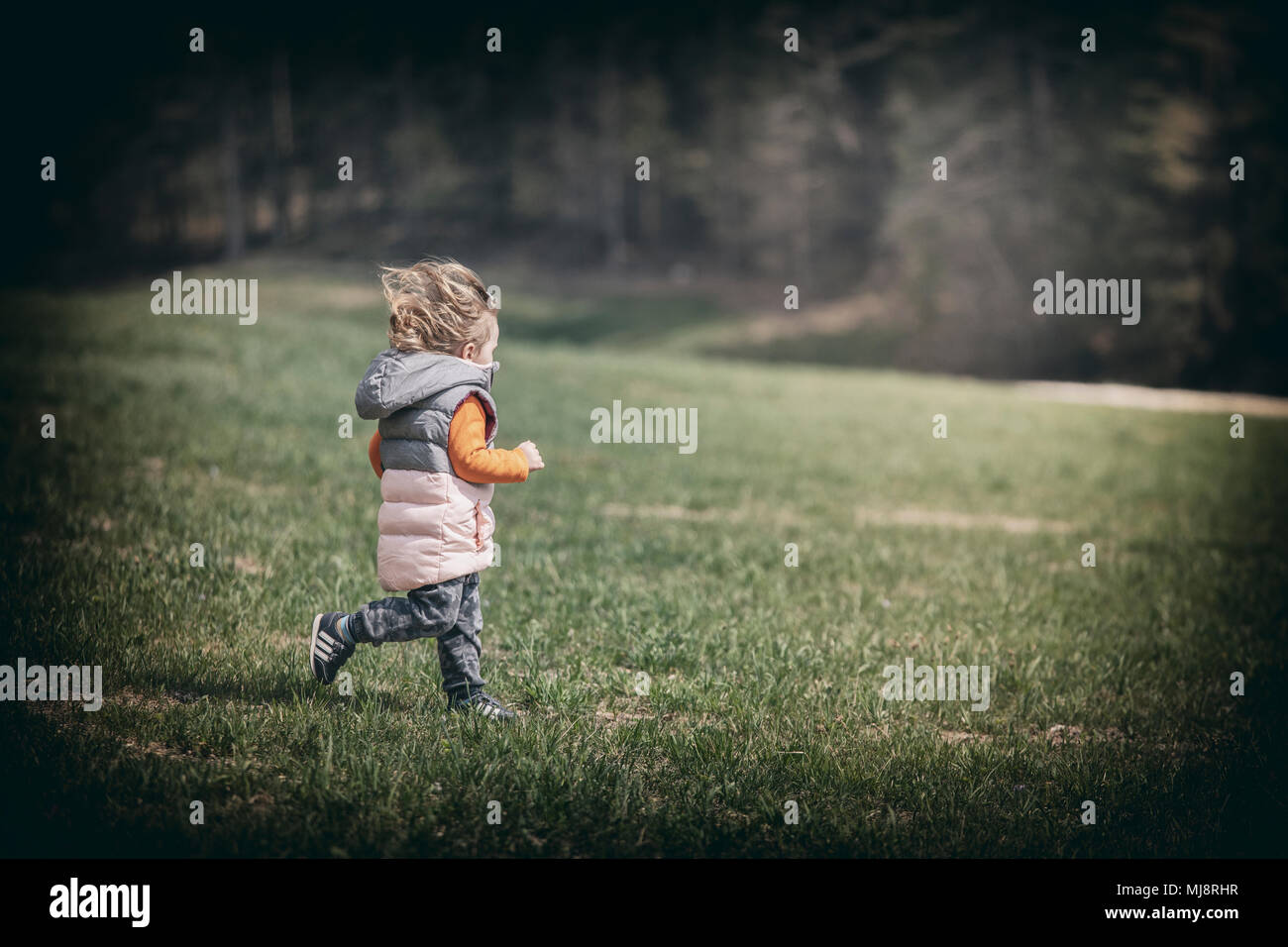little female child running on grass lomo style image Stock Photo - Alamy