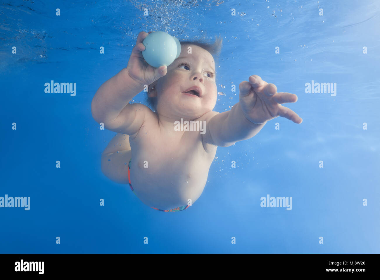 Playing ball swimming pool hi-res stock photography and images - Alamy