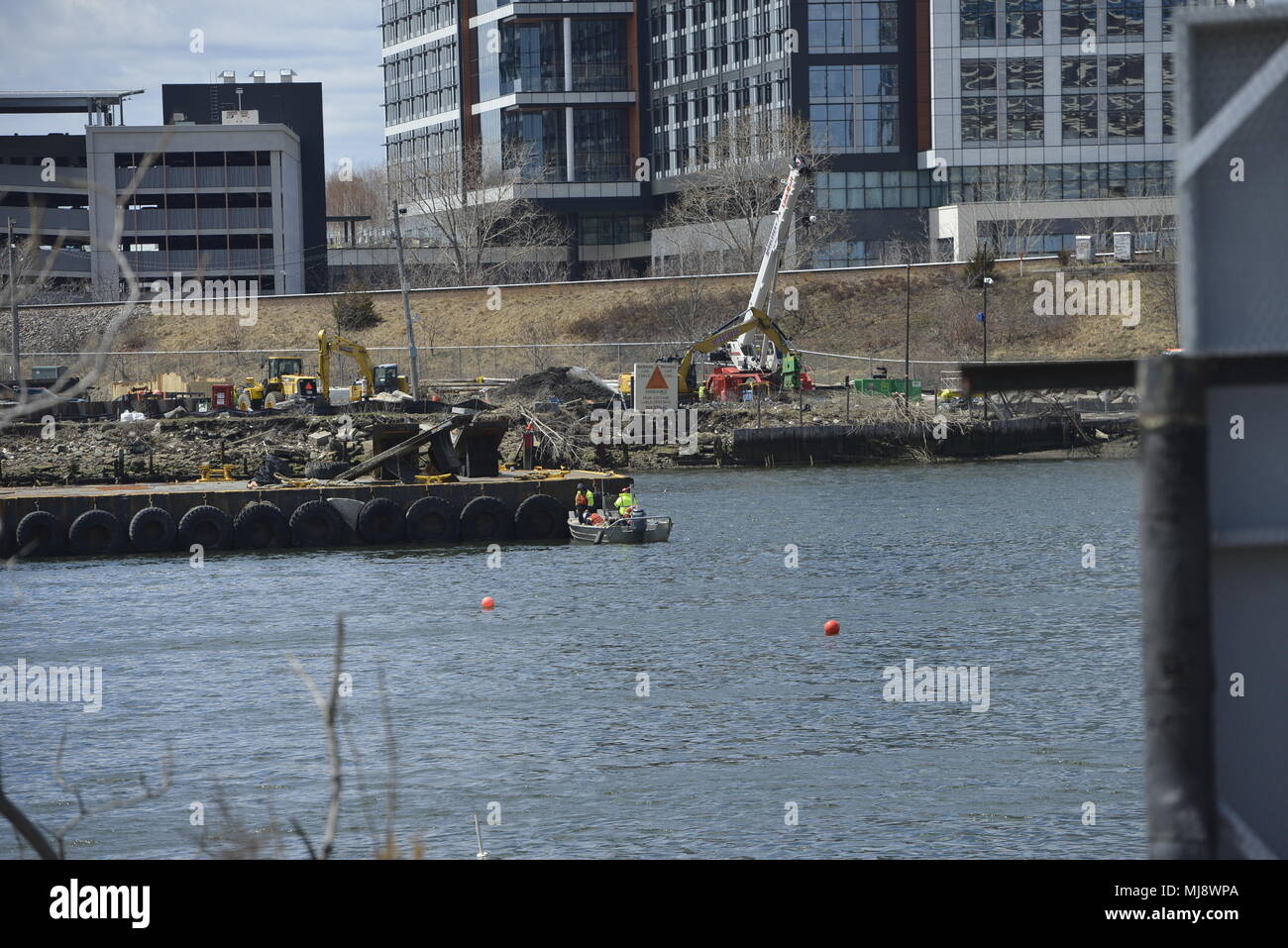 A boat crew from Clean Harbor is working to locate the source of the ...