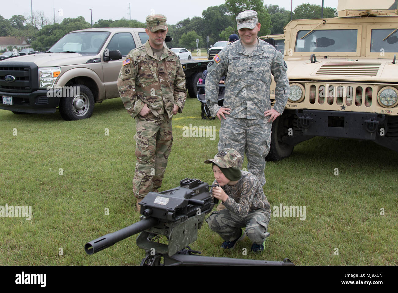 A young visitor interacts with a MK19 automatic grenade launcher at the ...