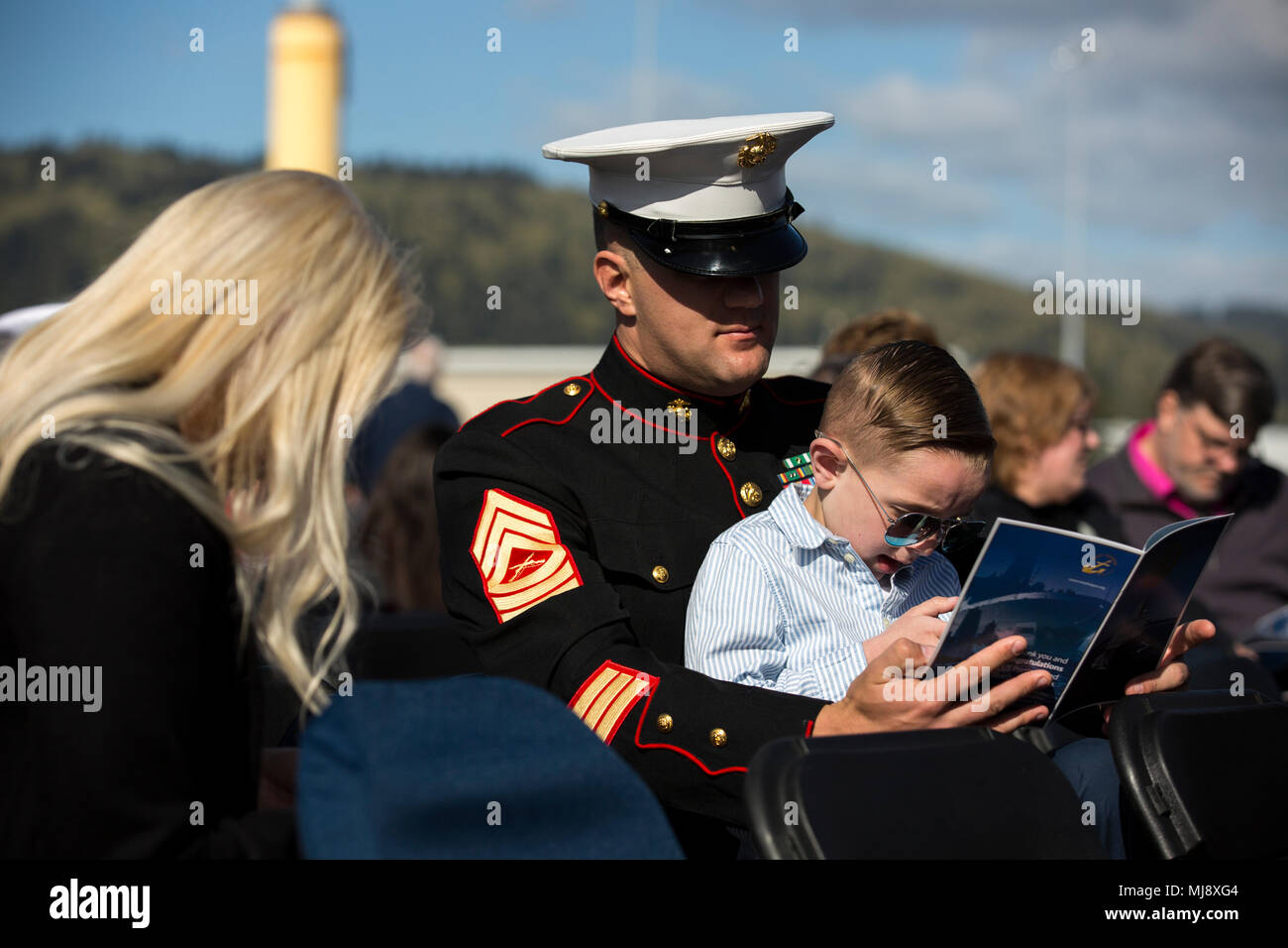 Master Sgt. Paul D. Tritch and his son read a program guide before the ...