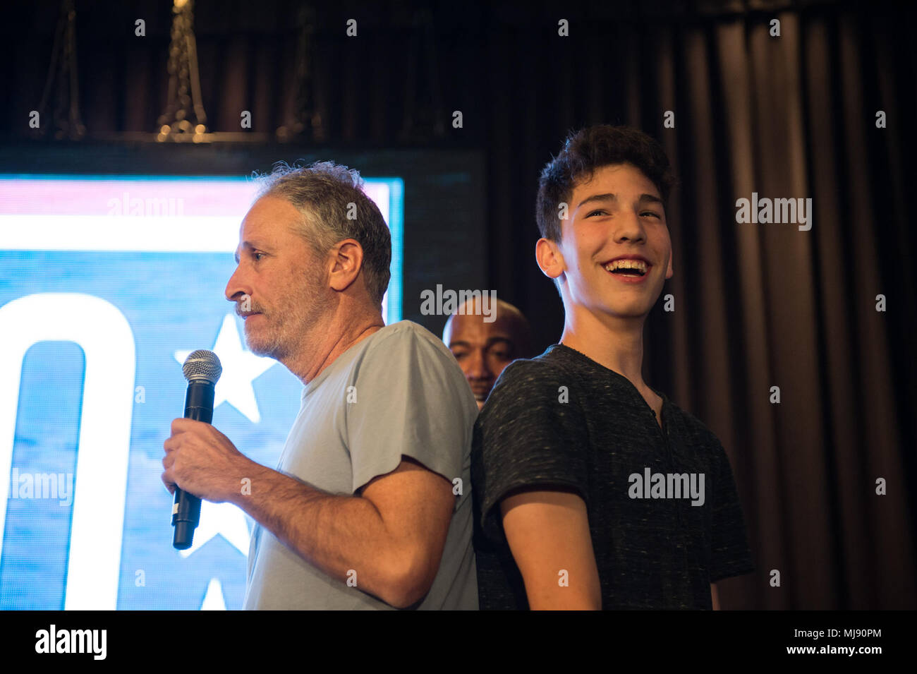 Comedian Jon Stewart jokes about his height vs a teenager during the ...