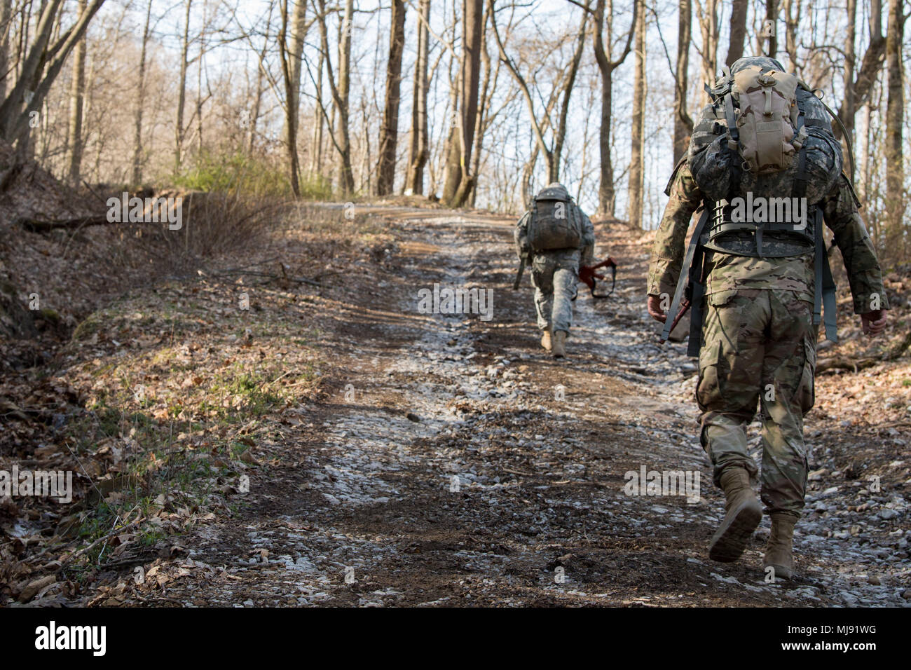 West Virginia National Guard Soldiers trek up an incline while ...