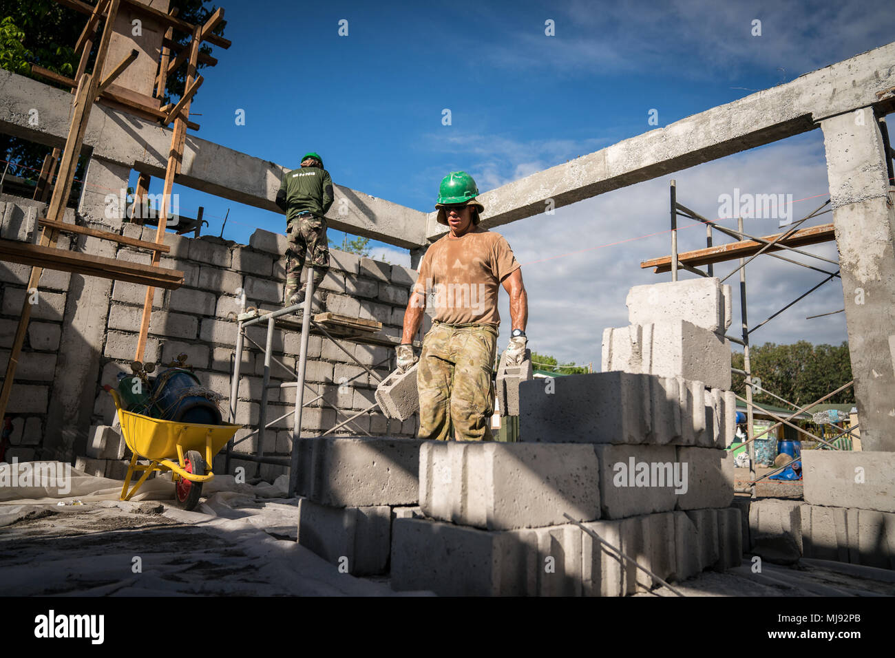 Royal Australian Army Sapper Tim Quirk carries concrete blocks during ...