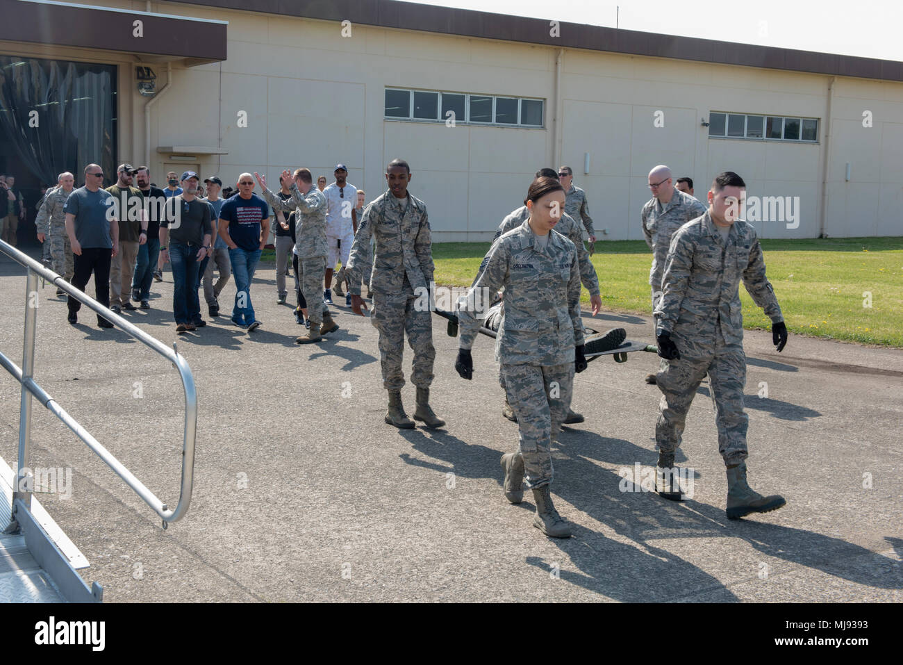 Airmen from the 374th Medical Support Squadron carry a gurney in ...
