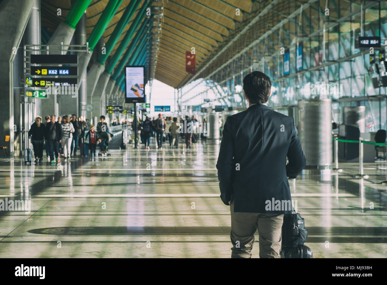 Close up of businessman carrying suitcase while walking through a ... Close up of businessman carrying suitcase while walking through a ...