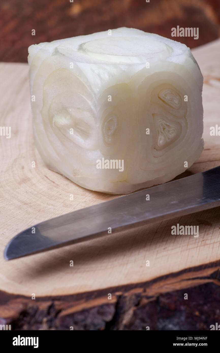 an onion cut into a cube on wood Stock Photo - Alamy