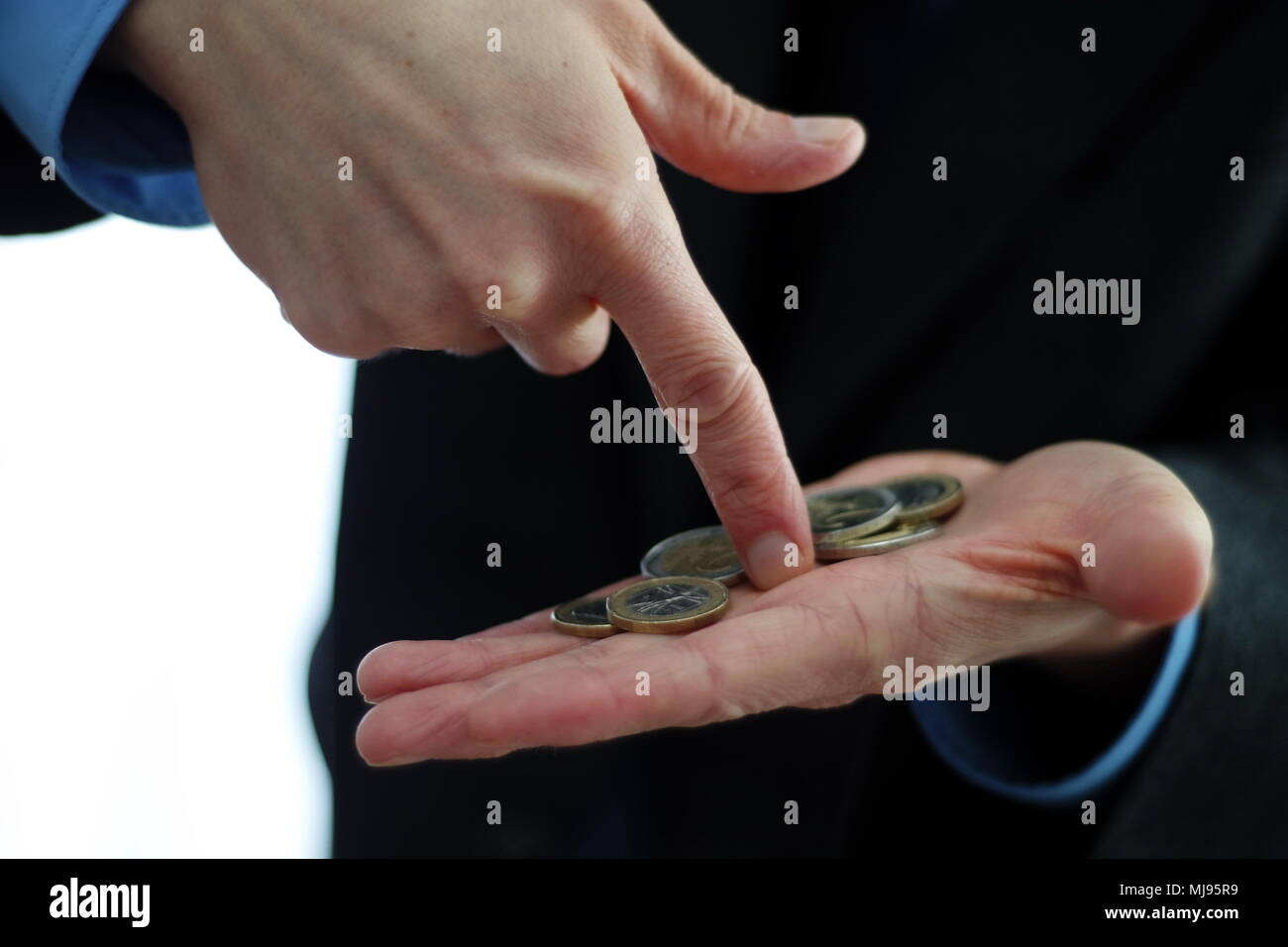 Human hands holding coins hi-res stock photography and images - Alamy