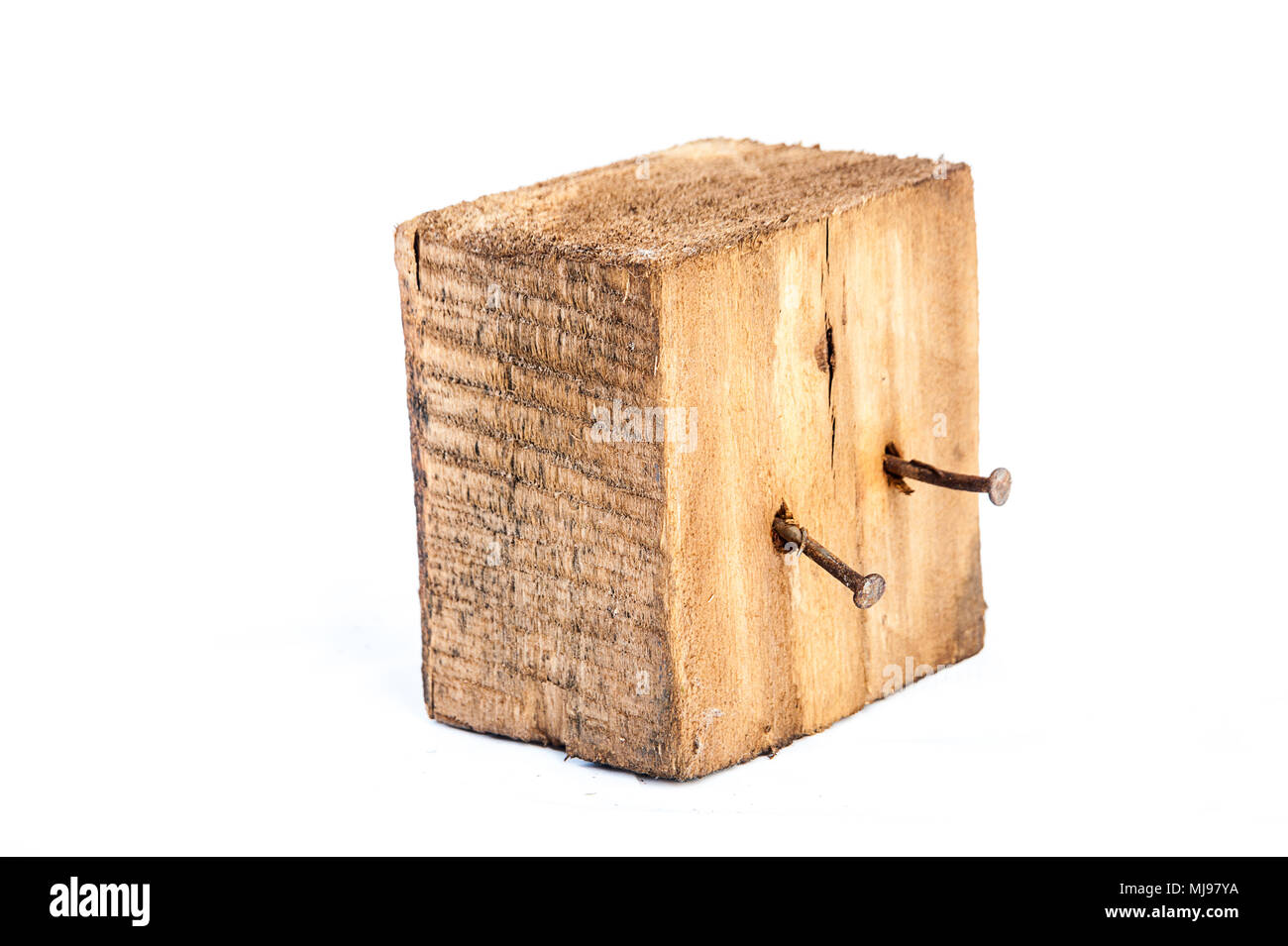 Big old dark cube is cut out from a solid trunk of an old wood ...