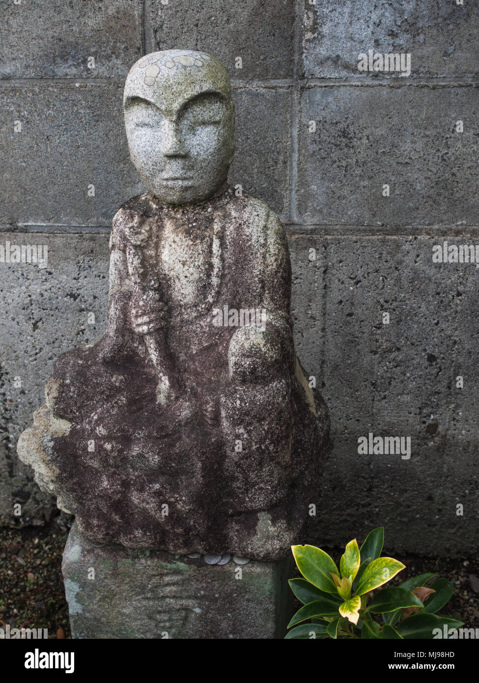 Statue of Buddhist deity at roadside shrine, Ehime, Shikoku, Japan ...