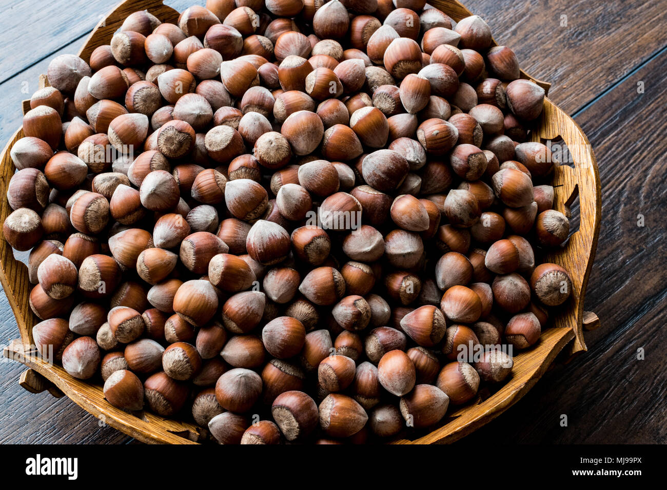 Stack of Hazelnuts in wooden bowl. (organic food Stock Photo - Alamy