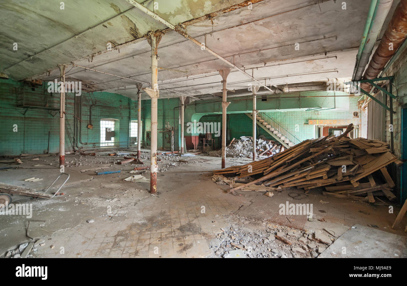 Destroyed production room of an old abandoned textile factory with ...