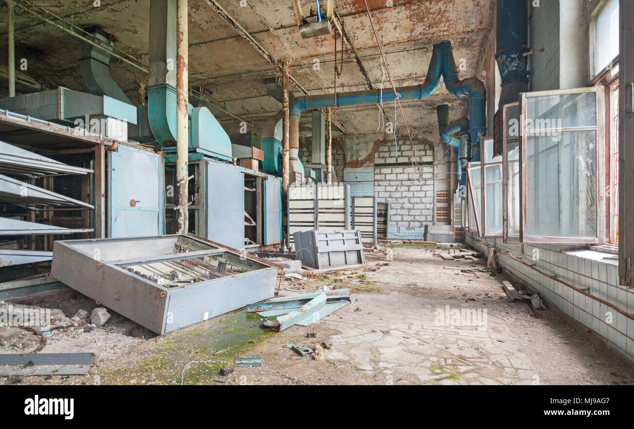 Destroyed production room of an old abandoned textile factory with ...