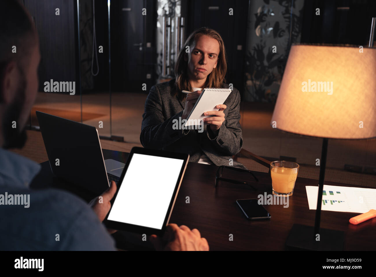 Working process at night loft office. Group of young coworkers making ...
