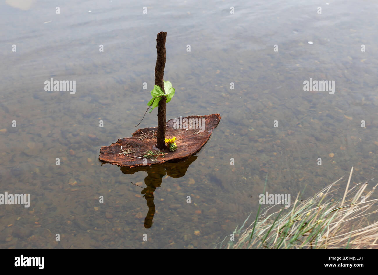 Closeup of a bark boat with mast floating on water Stock Photo - Alamy