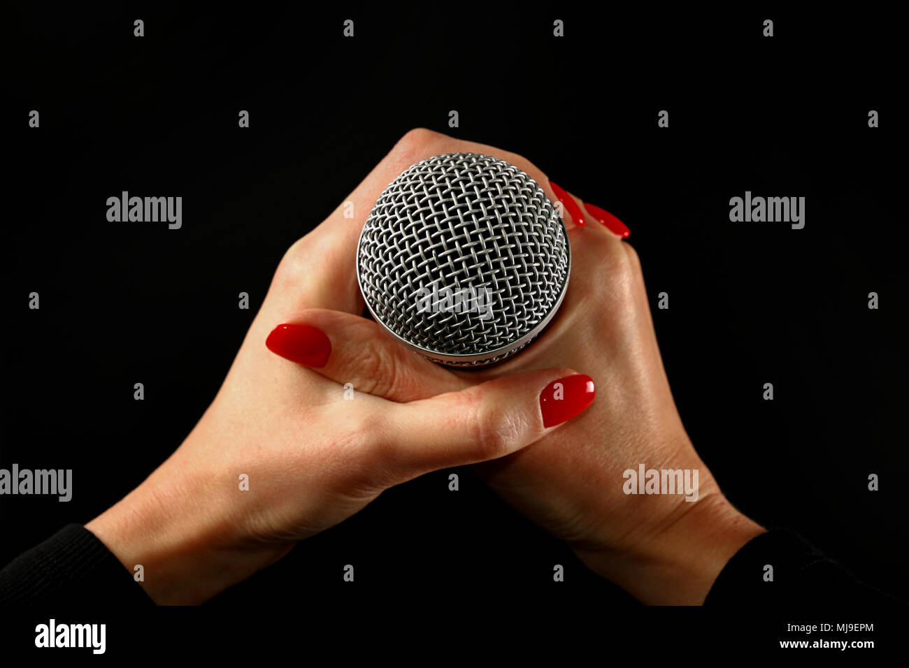 Holding mic with both hands hi-res stock photography and images - Alamy