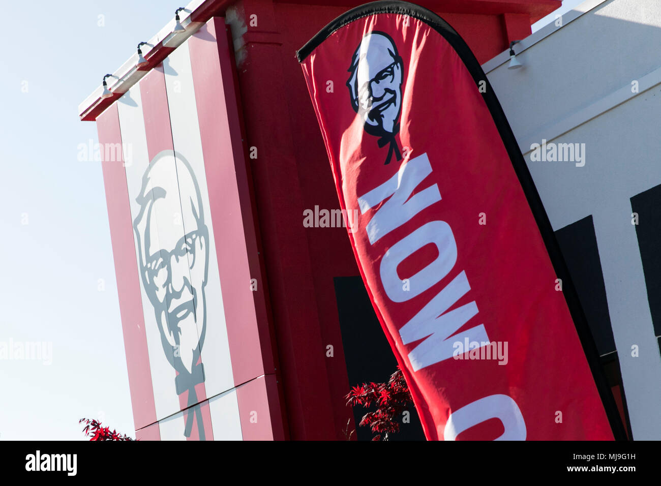 A logo sign outside of a KFC (Kentucky Fried Chicken) fast food ...