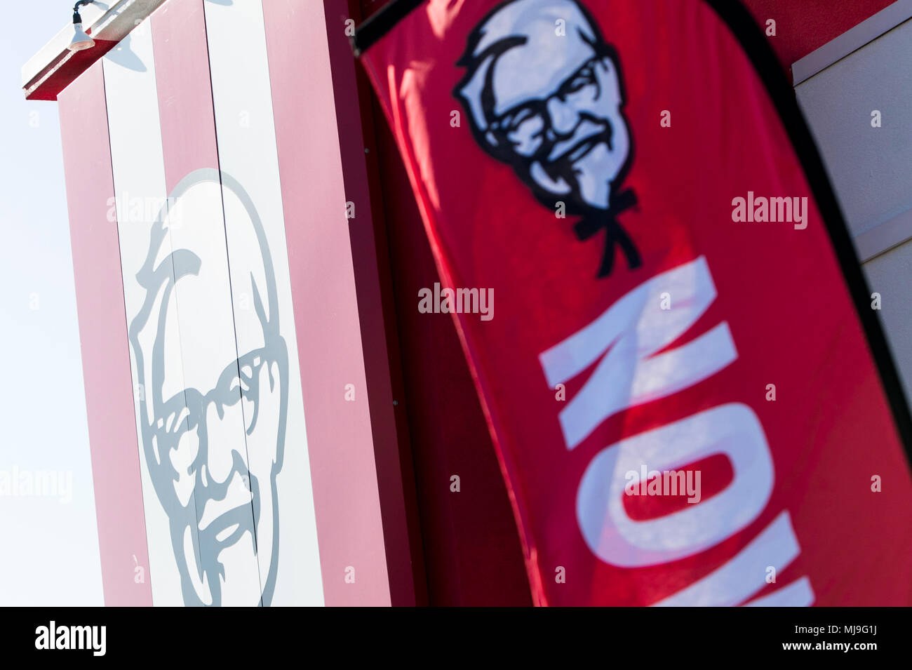 A logo sign outside of a KFC (Kentucky Fried Chicken) fast food ...