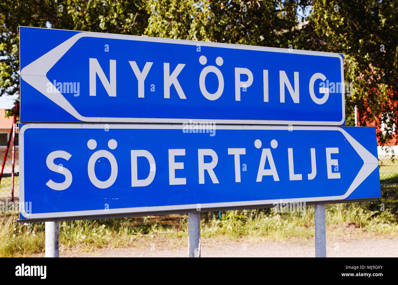 Swedish road sign post with directional signs to the two towns Nykoping ...