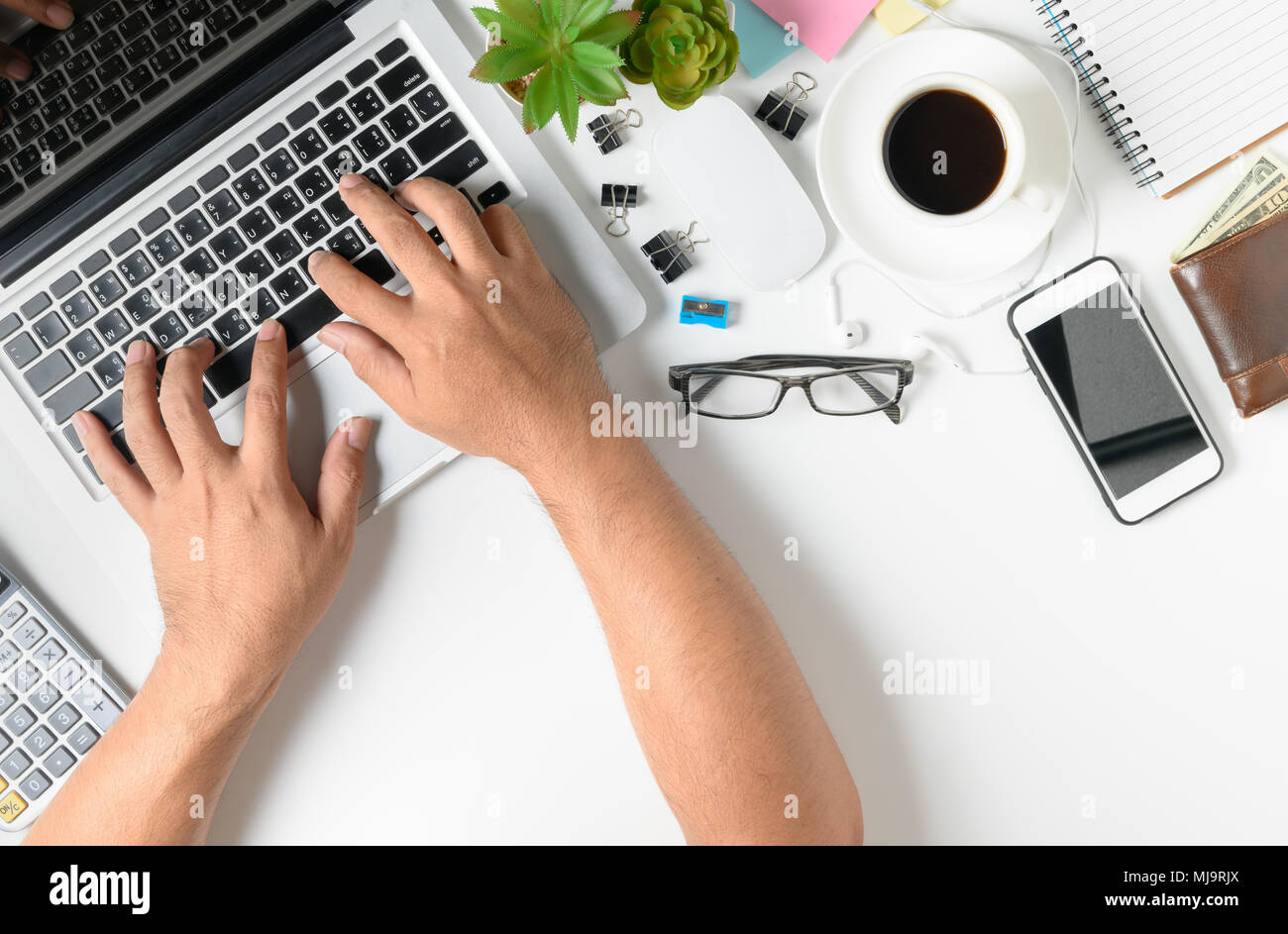 Business man typing laptop on modern white office desk table with ...