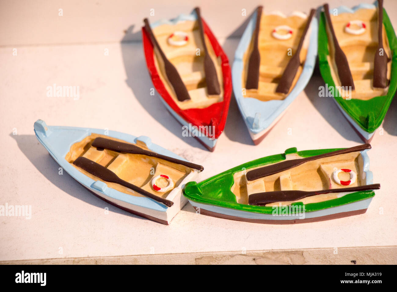 Set of small colorful wooden model boats Stock Photo - Alamy