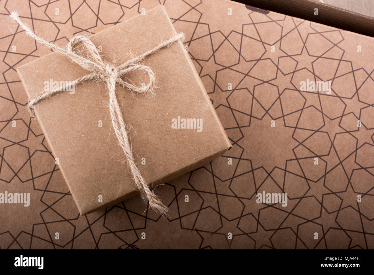 Gift box of brown color on a paper with pattern background Stock Photo ...