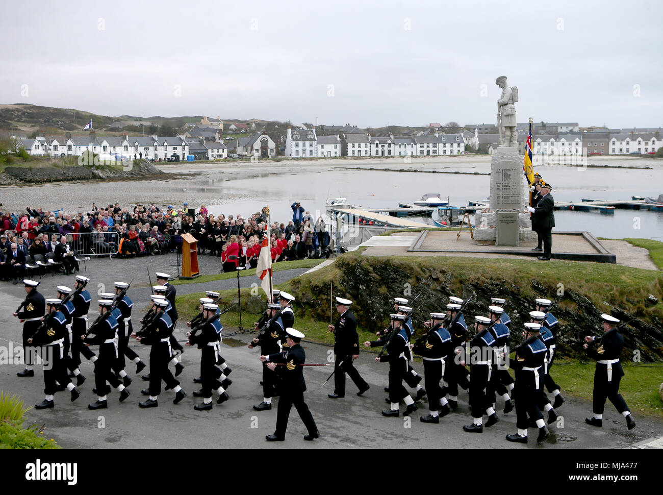 A commemoration service takes places at the War Memorial in Port Ellen ...