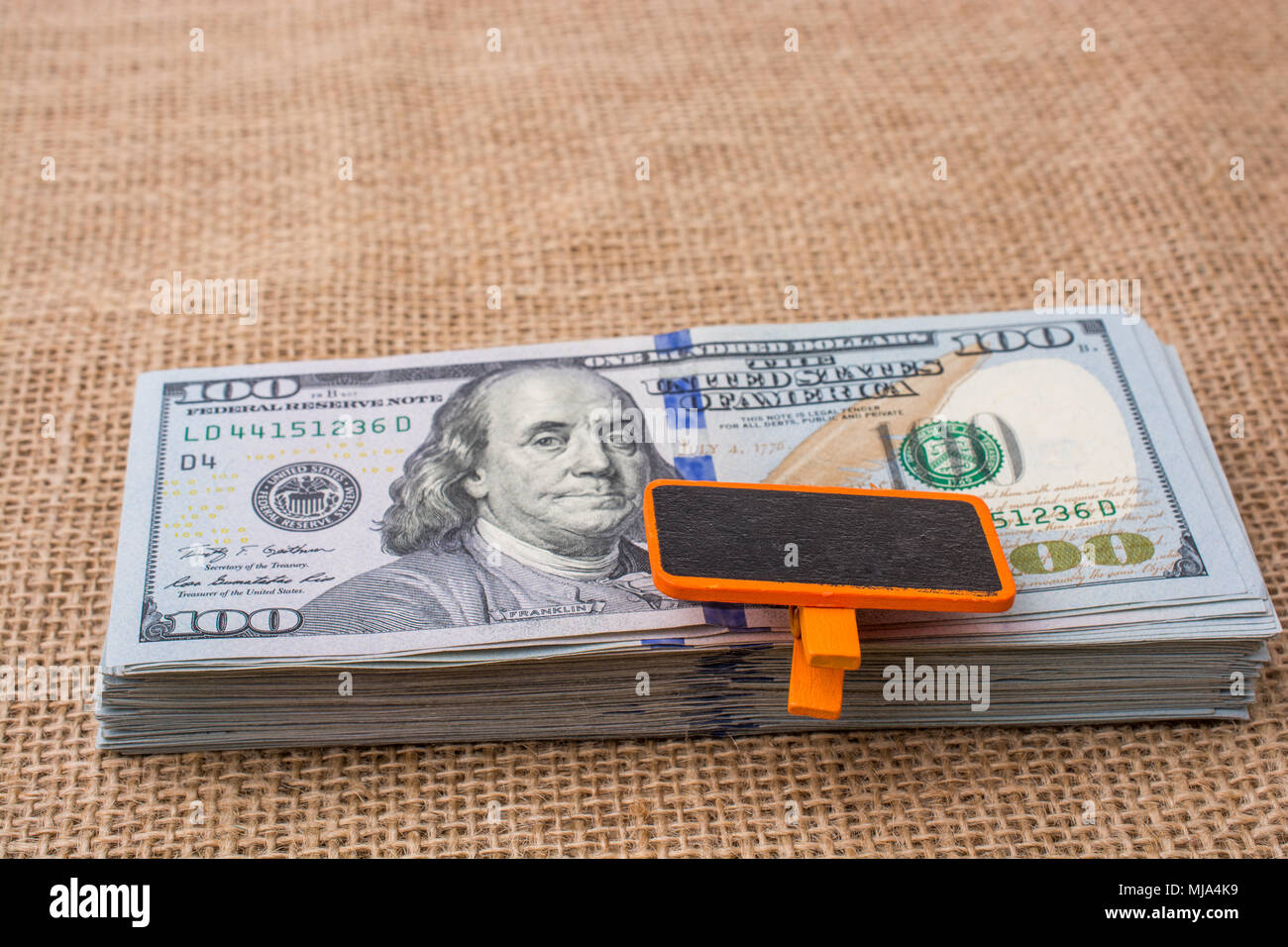 Notice board placed on the bundle of US dollar banknote Stock Photo - Alamy