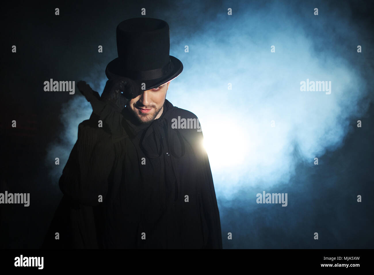 Man in black cloak with hood hi-res stock photography and images - Alamy