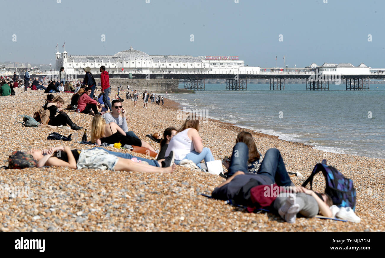 People enjoy the afternoon sunshine on the beach in Brighton, as ...