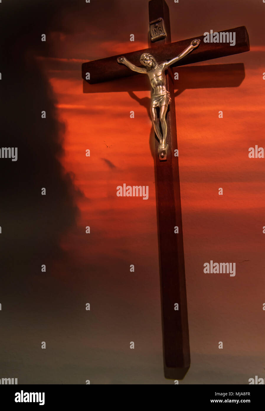 Crucifix on the red sunset - dramatic view Stock Photo - Alamy