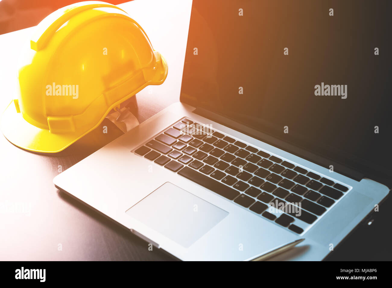 Engineer working table with computer and safety helmet Stock Photo - Alamy