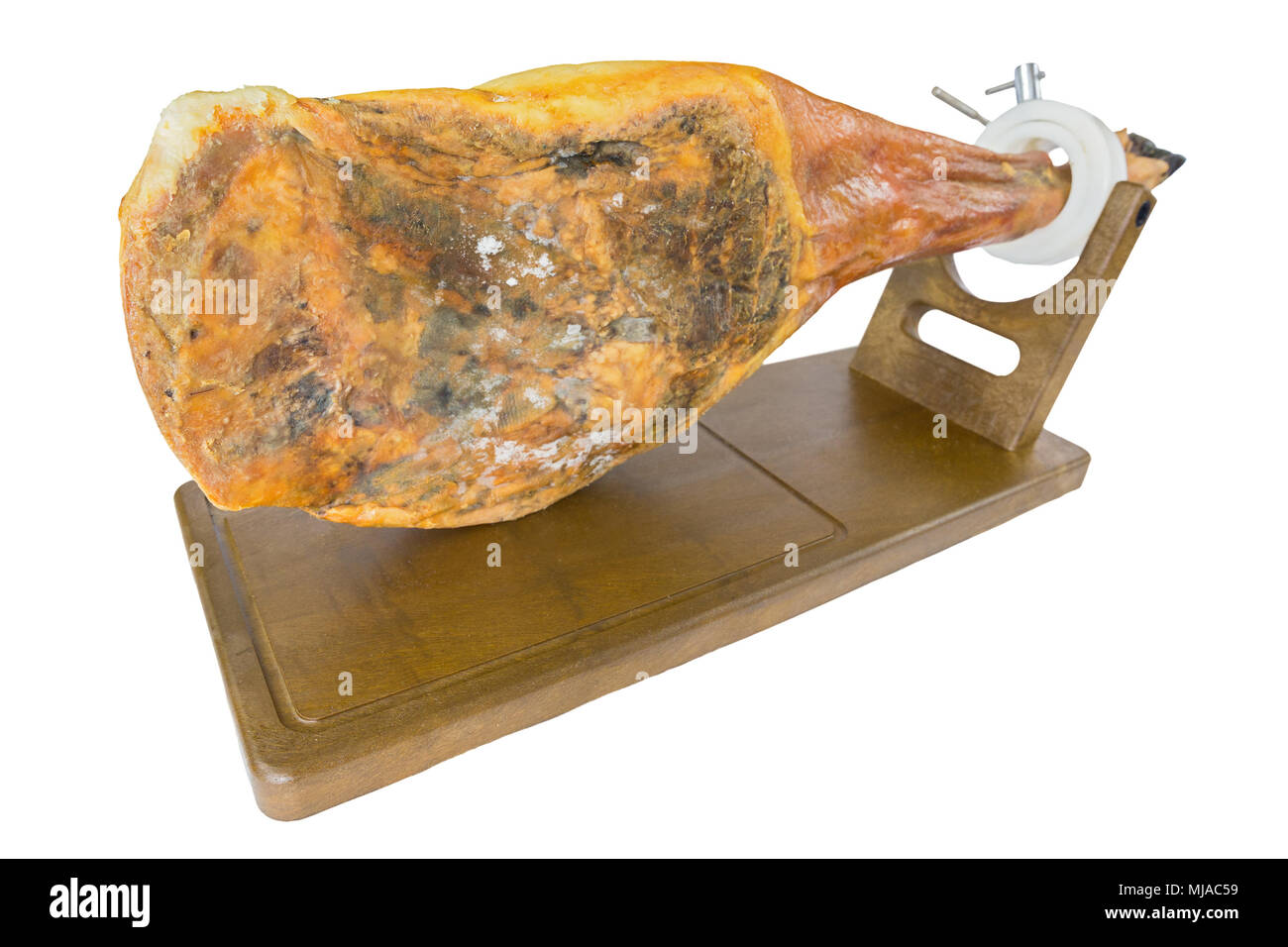 Edge view of whole serrano ham leg over wood, white background Stock ...