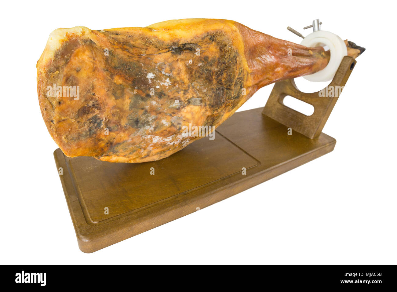 Edge view of whole serrano ham leg over wood, white background Stock ...