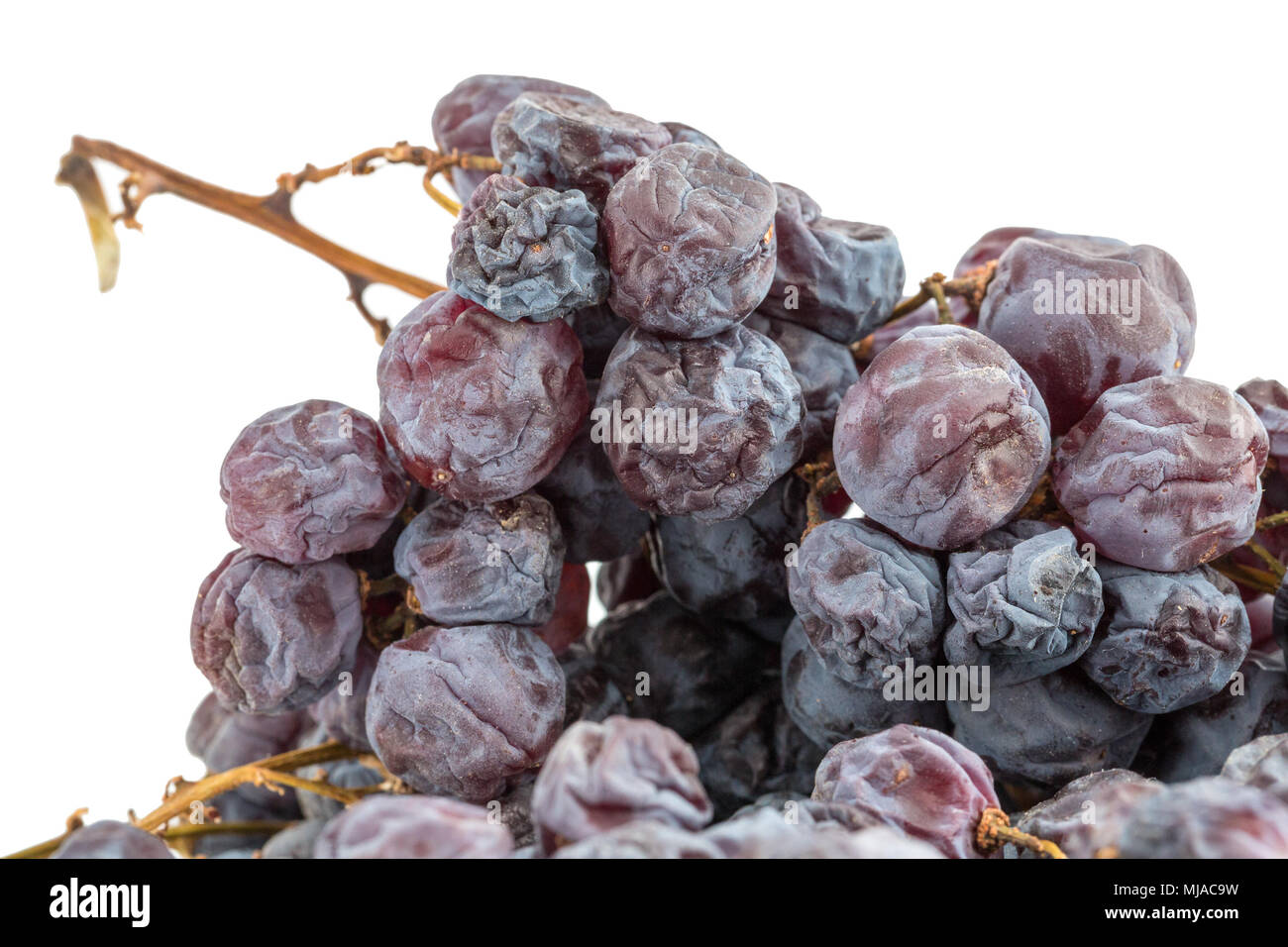 Detailed view of bunch of raisins over white Stock Photo - Alamy