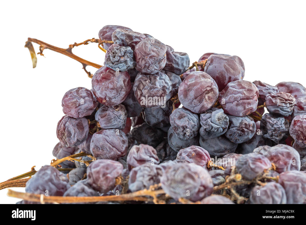 Detailed view of bunch of raisins over white Stock Photo - Alamy