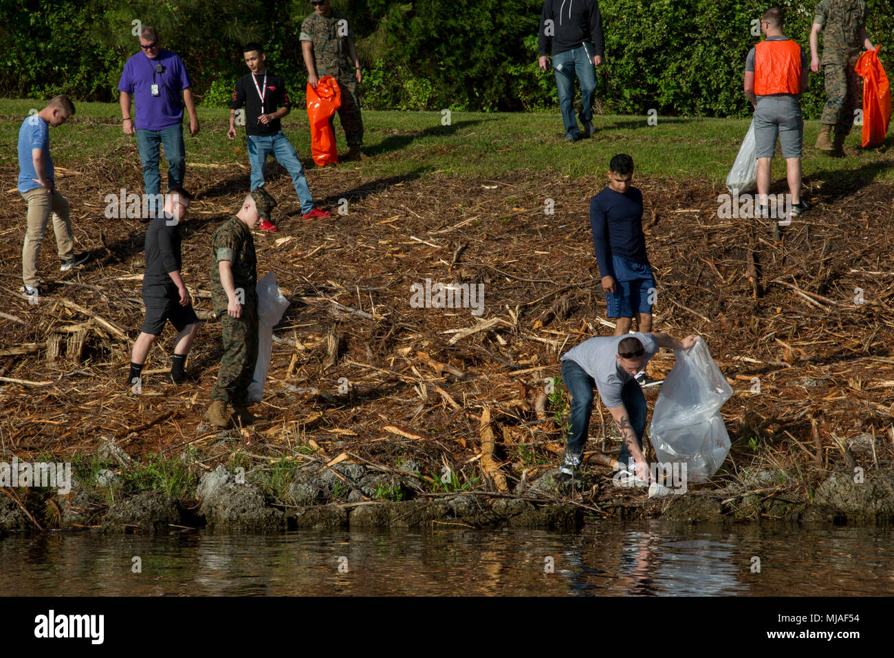 Marines conduct a shoreline clean-up at the marina on Marine Corps Air ...