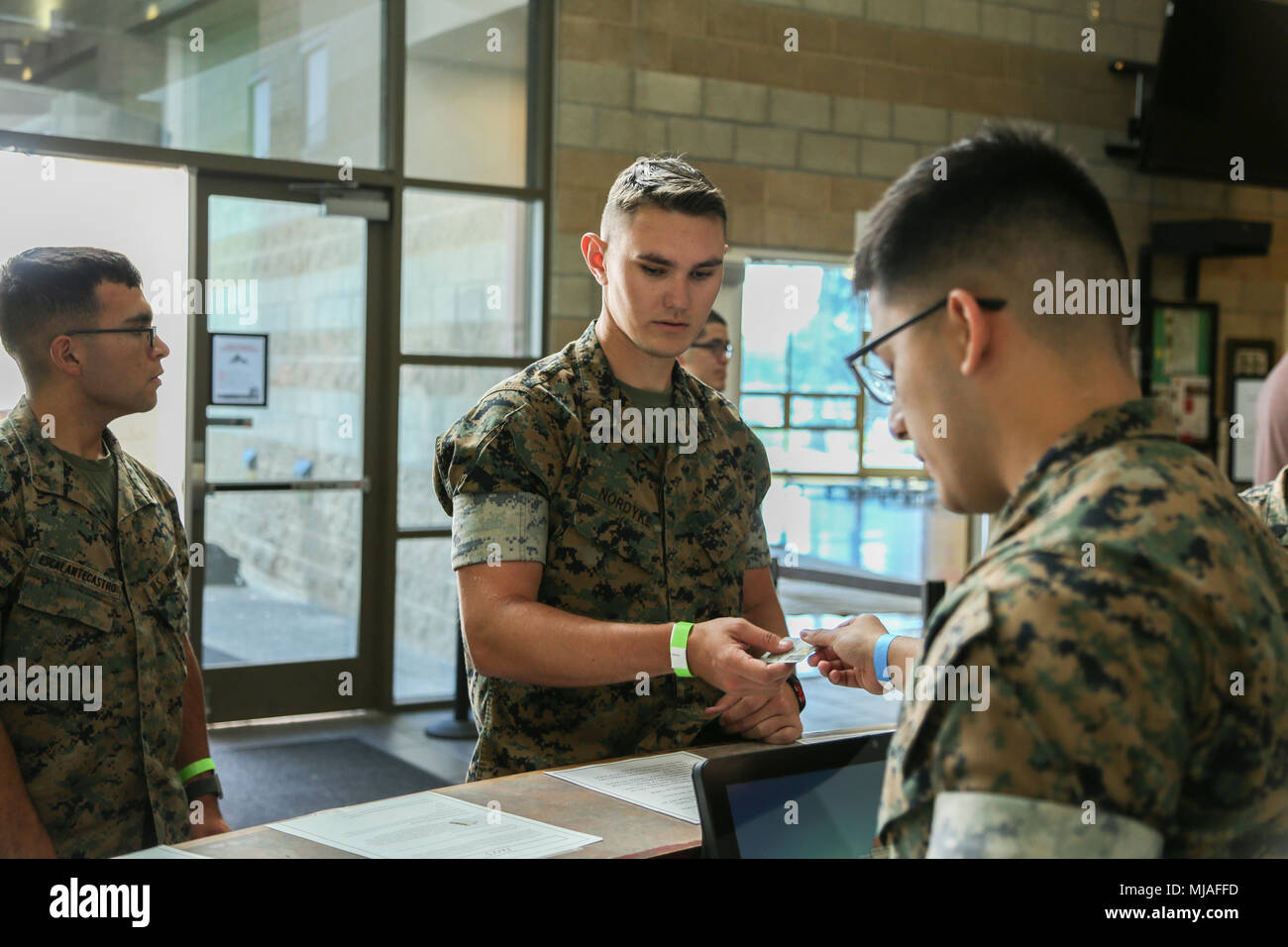A U.S. Marine role-playing as an evacuee checks in to an evacuation ...