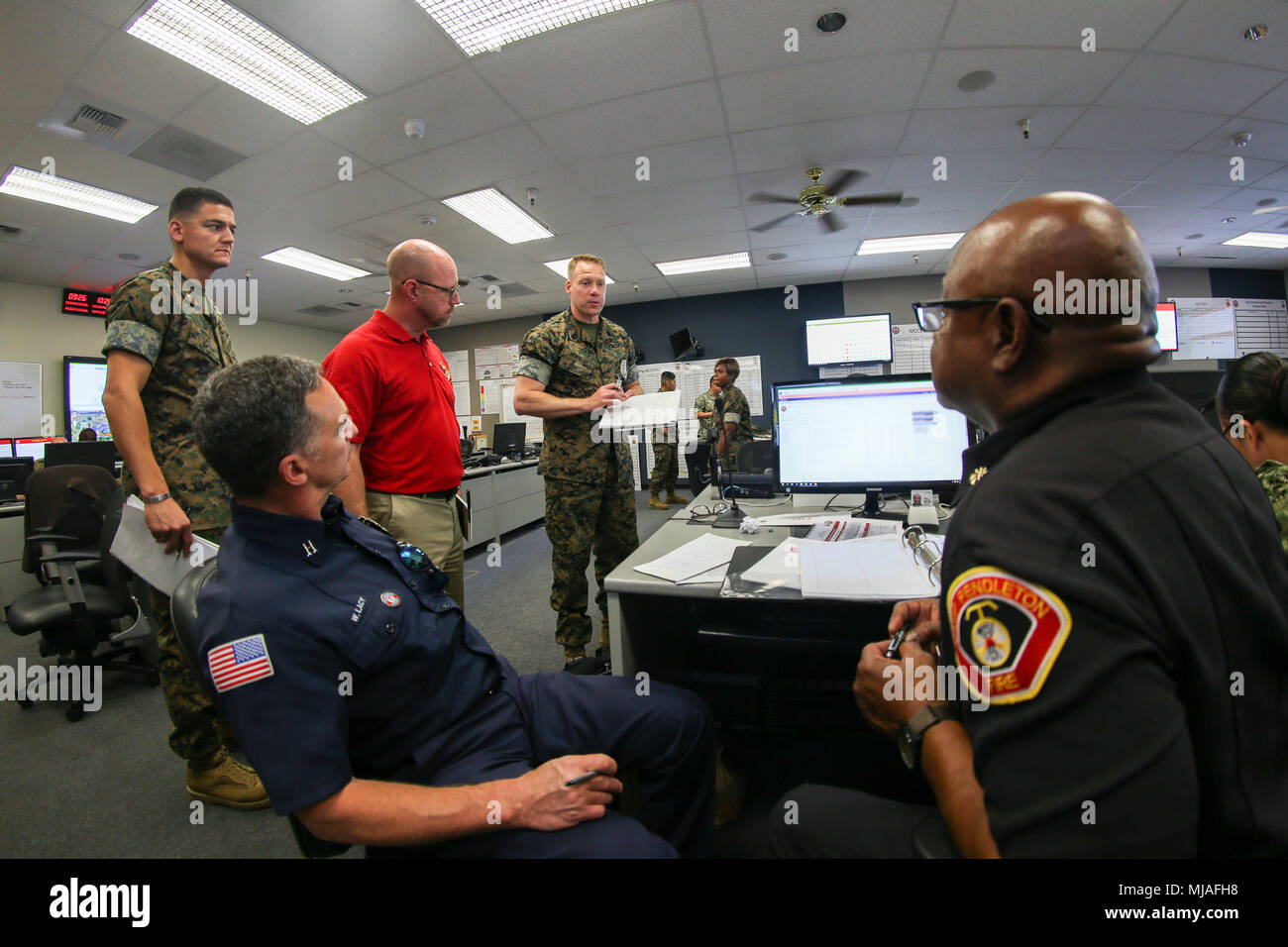 U.S. Marines and Department of Defense personnel communicate in an ...