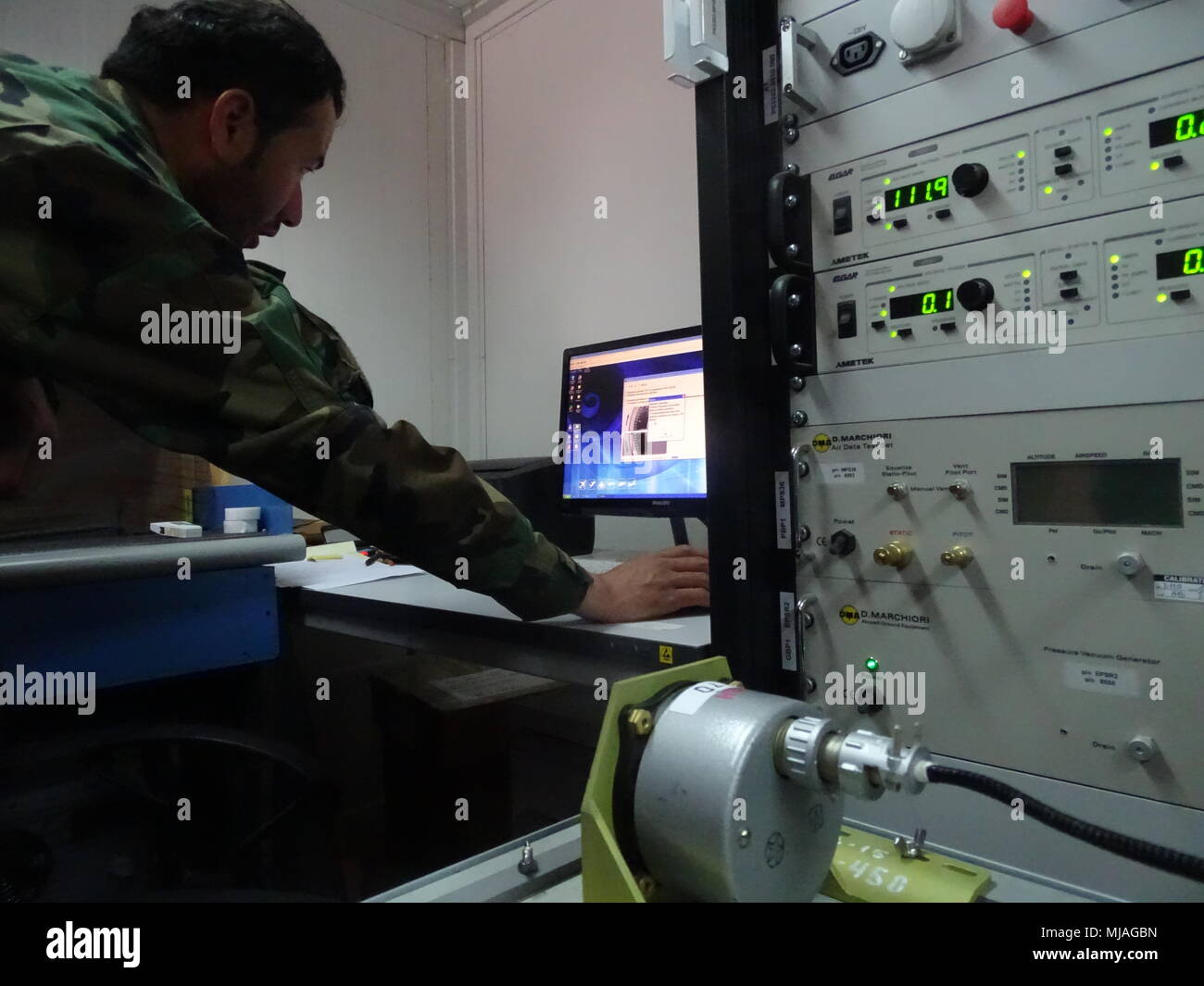 An Afghan Noncommissioned Officer (NCO) calibrates a Mi-17 helicopter ...