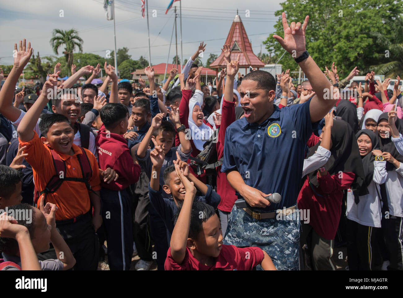 180426-N-OU129-301 TAWAU, Malaysia (April 26, 2018) Chief Musician Chris Sams sings and dances ...