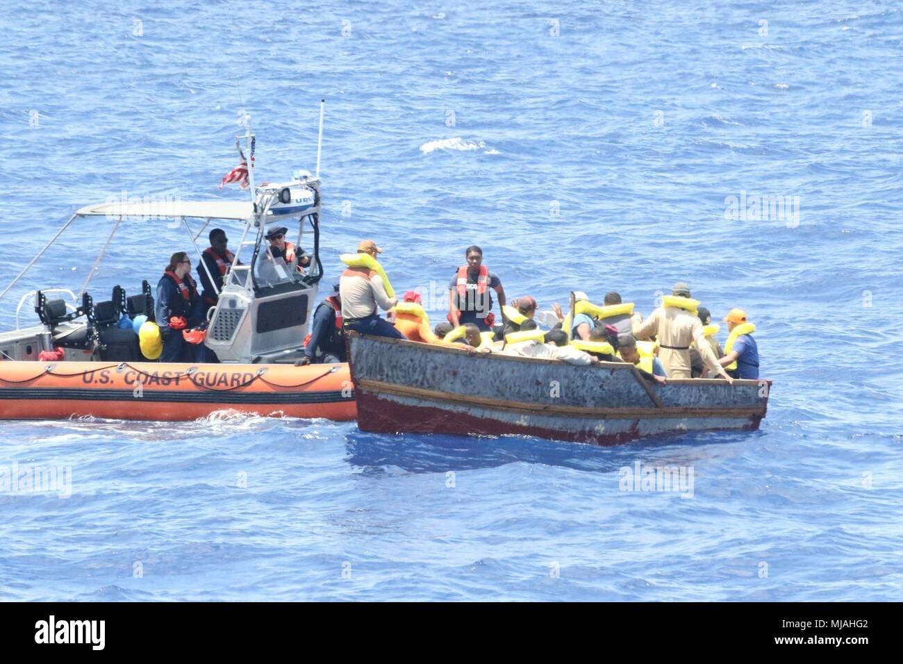 A Coast Guard Cutter Kathleen Moore boat crew interdicts a 25-foot ...