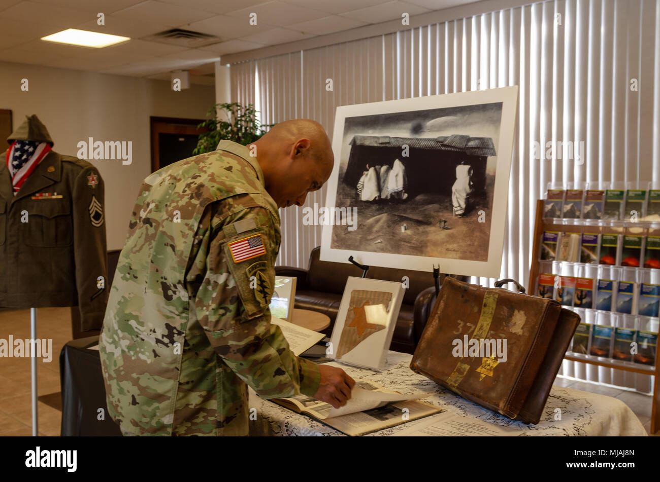 A 13th Expeditionary Sustainment Command Soldier looks at archives ...