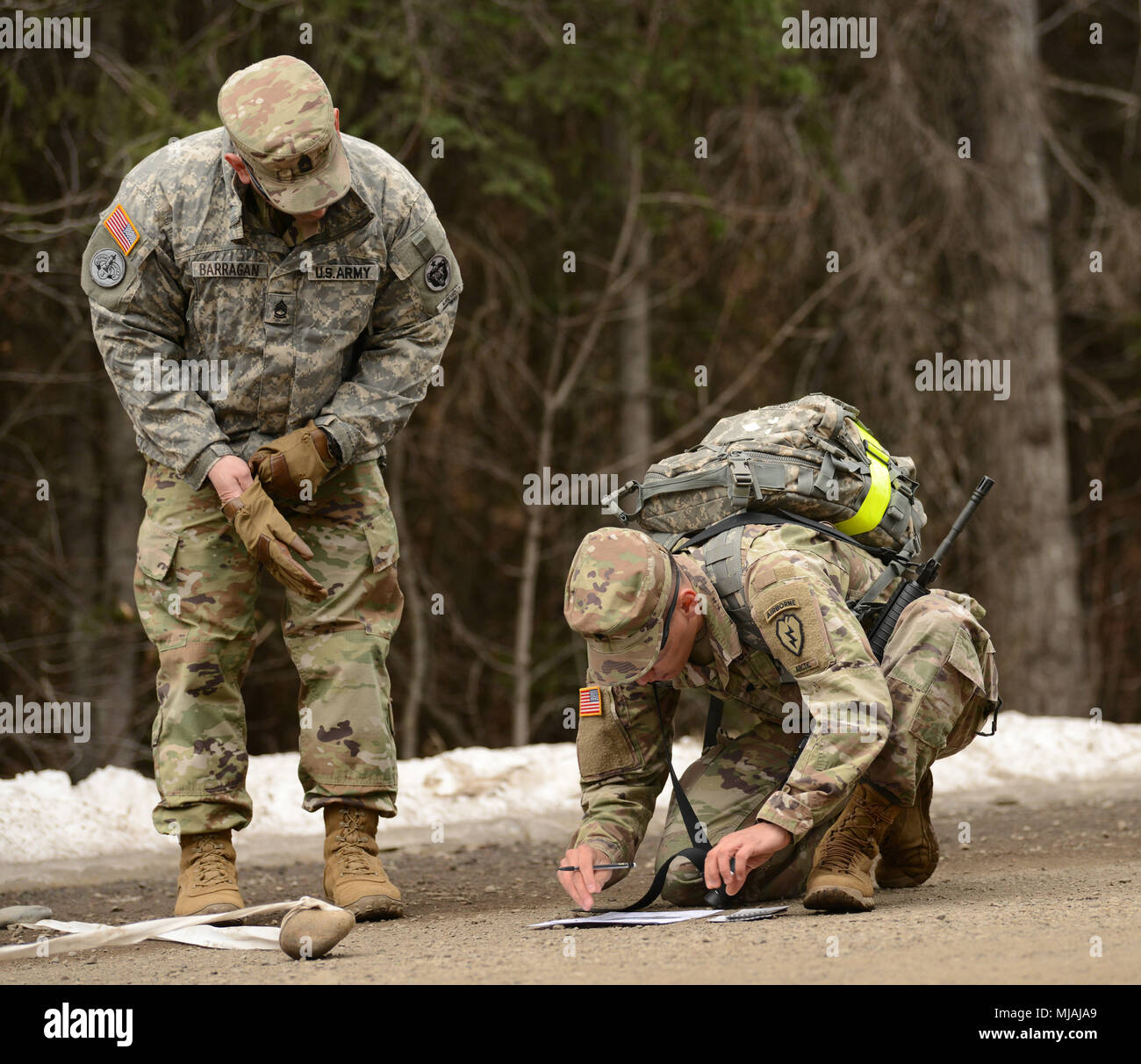Sgt. 1st Class Anthony Barragan observes as Spc. Aaron Barker of the ...