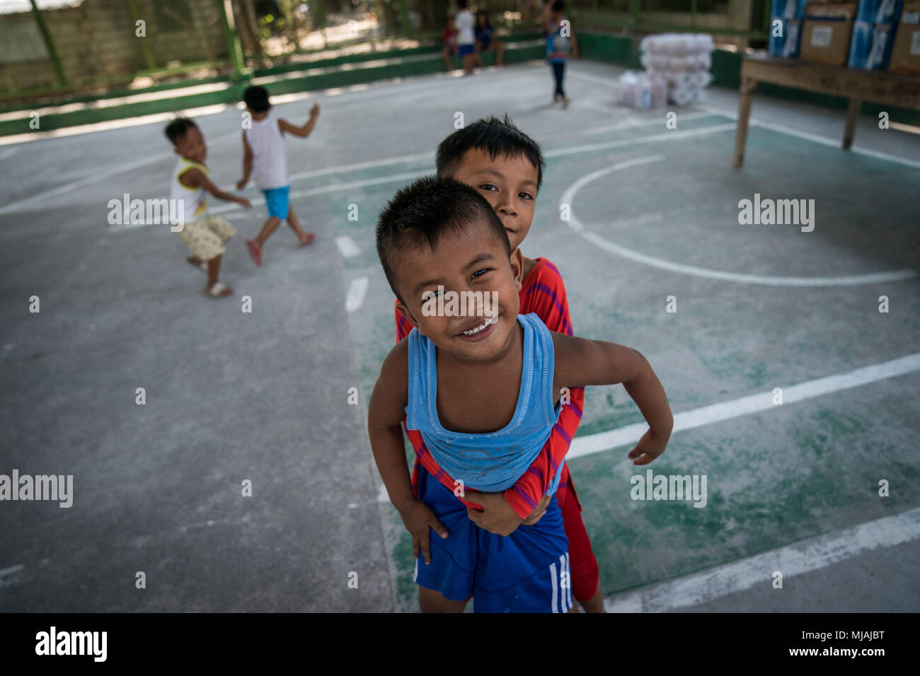 Kevin (front) is picked up by his friend while they play around during ...