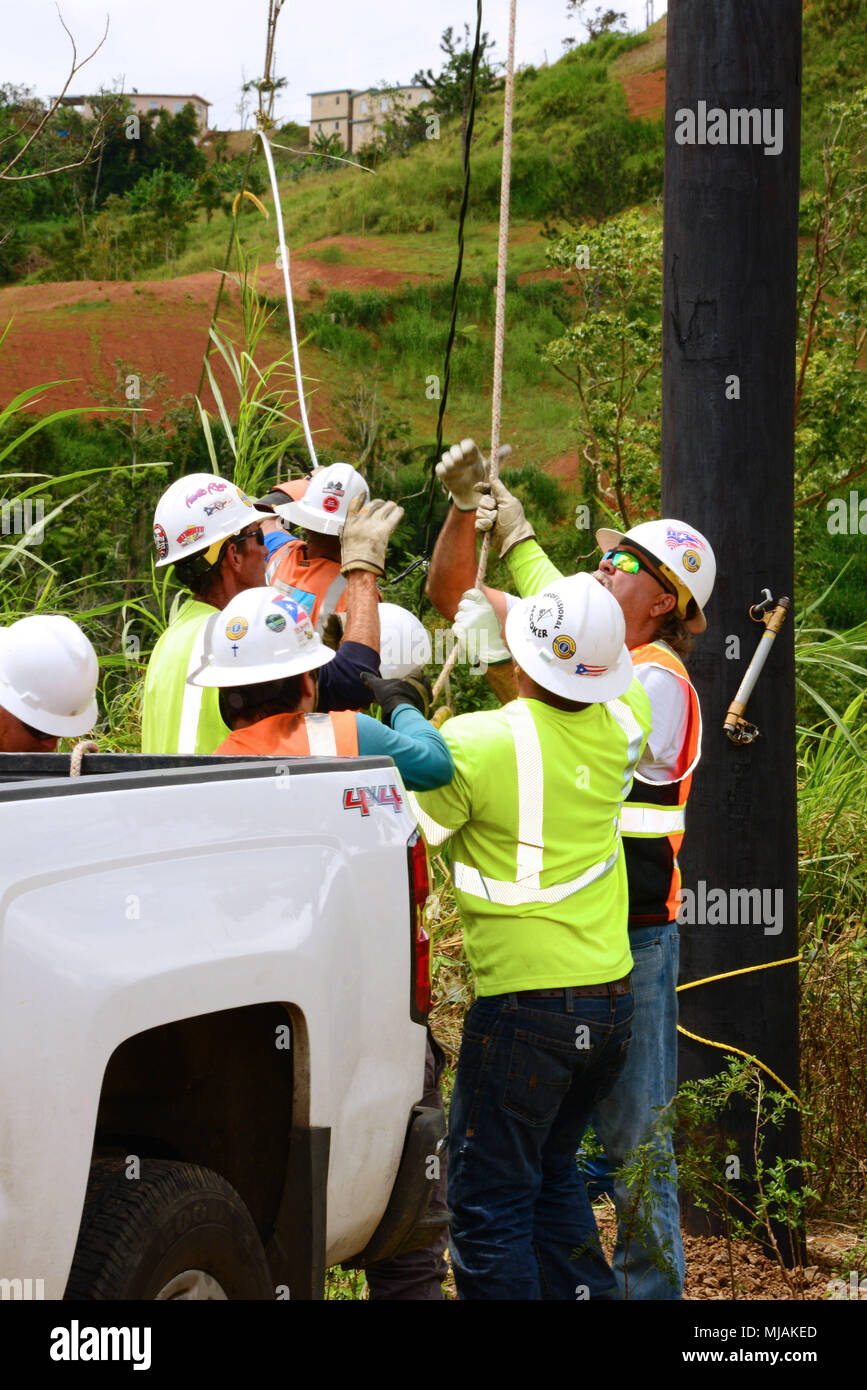 Electrical workers labor on a utility pole hi-res stock photography and ...